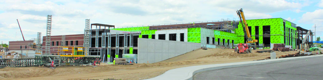 Bricklaying robot, masons work together at U-M Brighton hospital